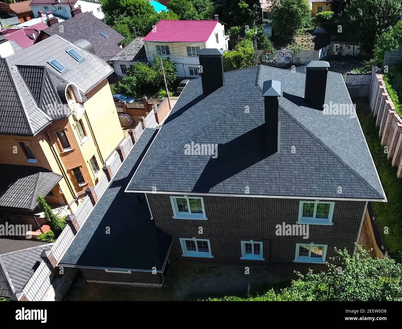 House with a roof from a bituminous tile. Bituminous tile for a roof. a ...