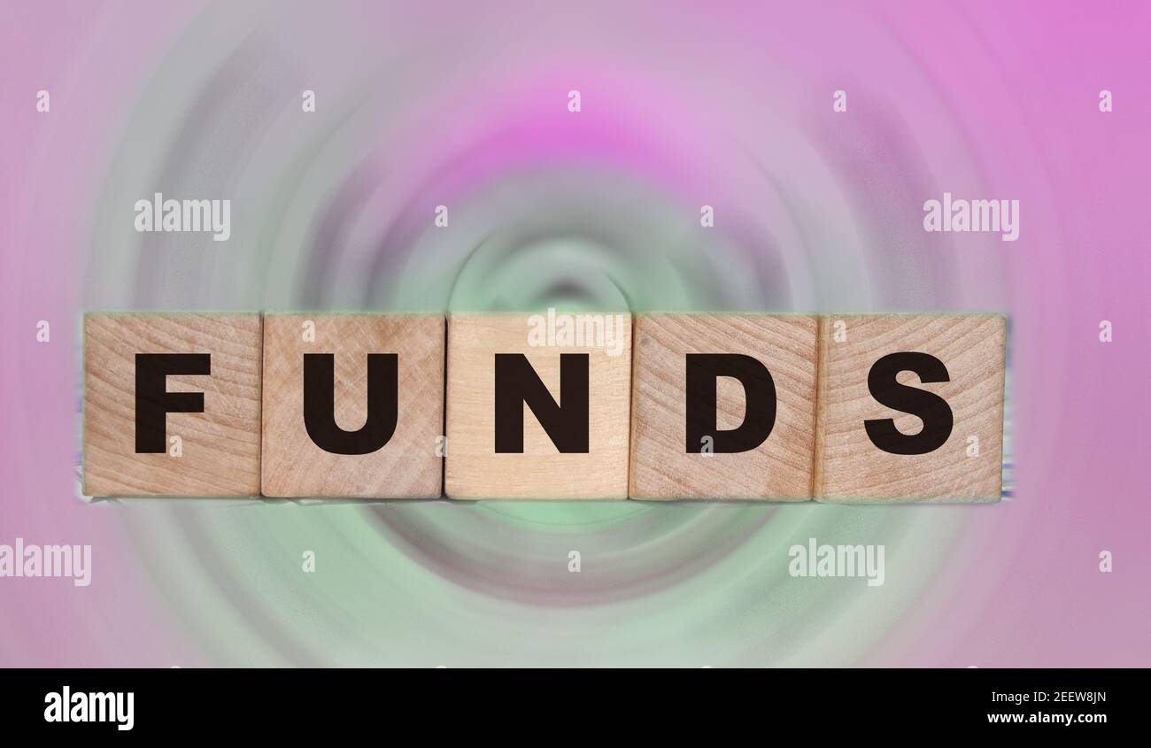 Funds word on wooden cube blocks over relaxed beach landscape. Business ...