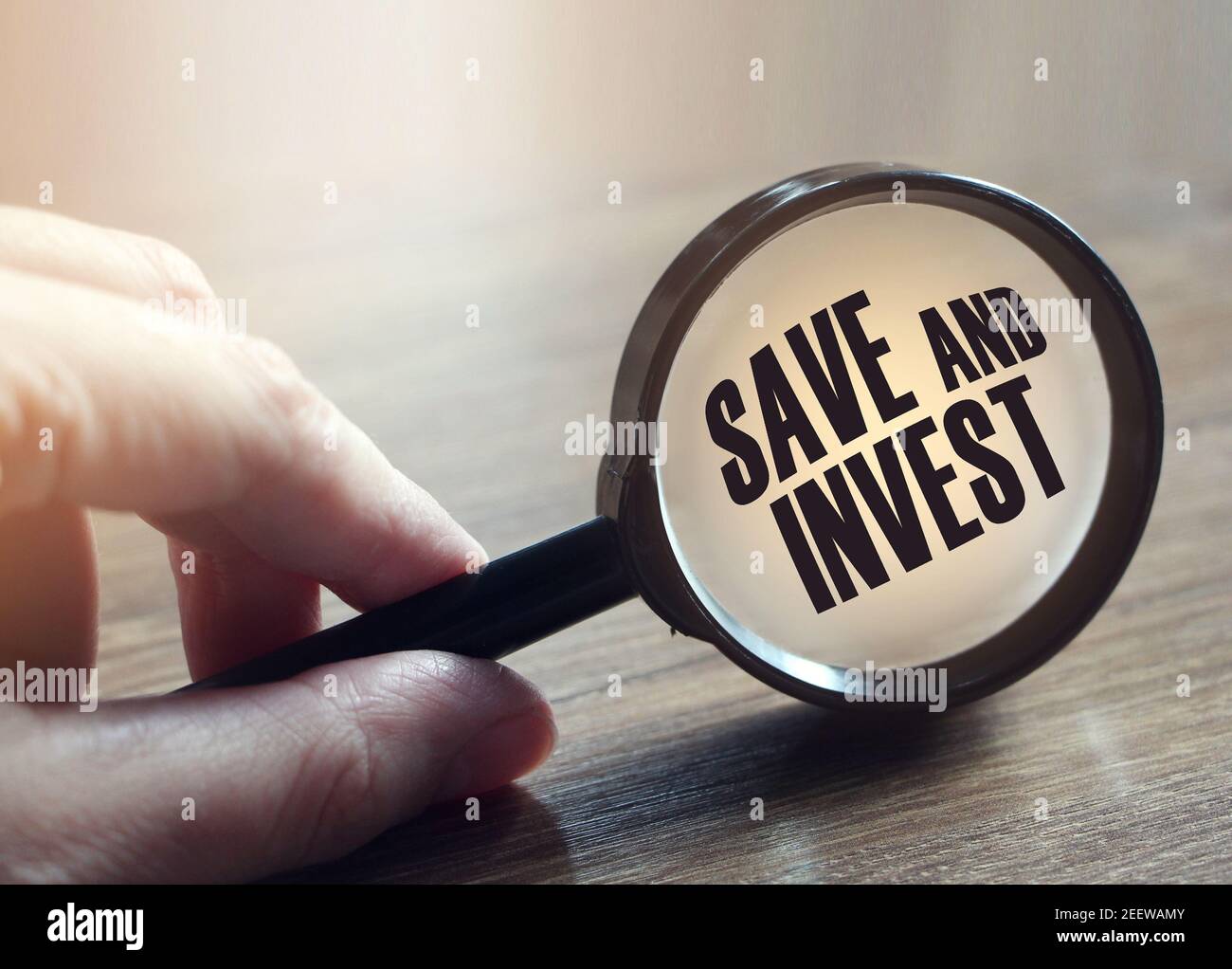 Save and invest under magnifying glass. Money saving trade and ...