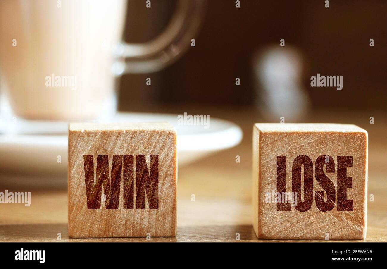 Win and Lose, on wooden cubes and cacao cup. Business success and ...