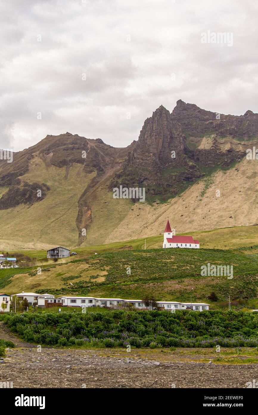 Church of Vik i Myrdal, mountains in the background, Iceland Stock ...