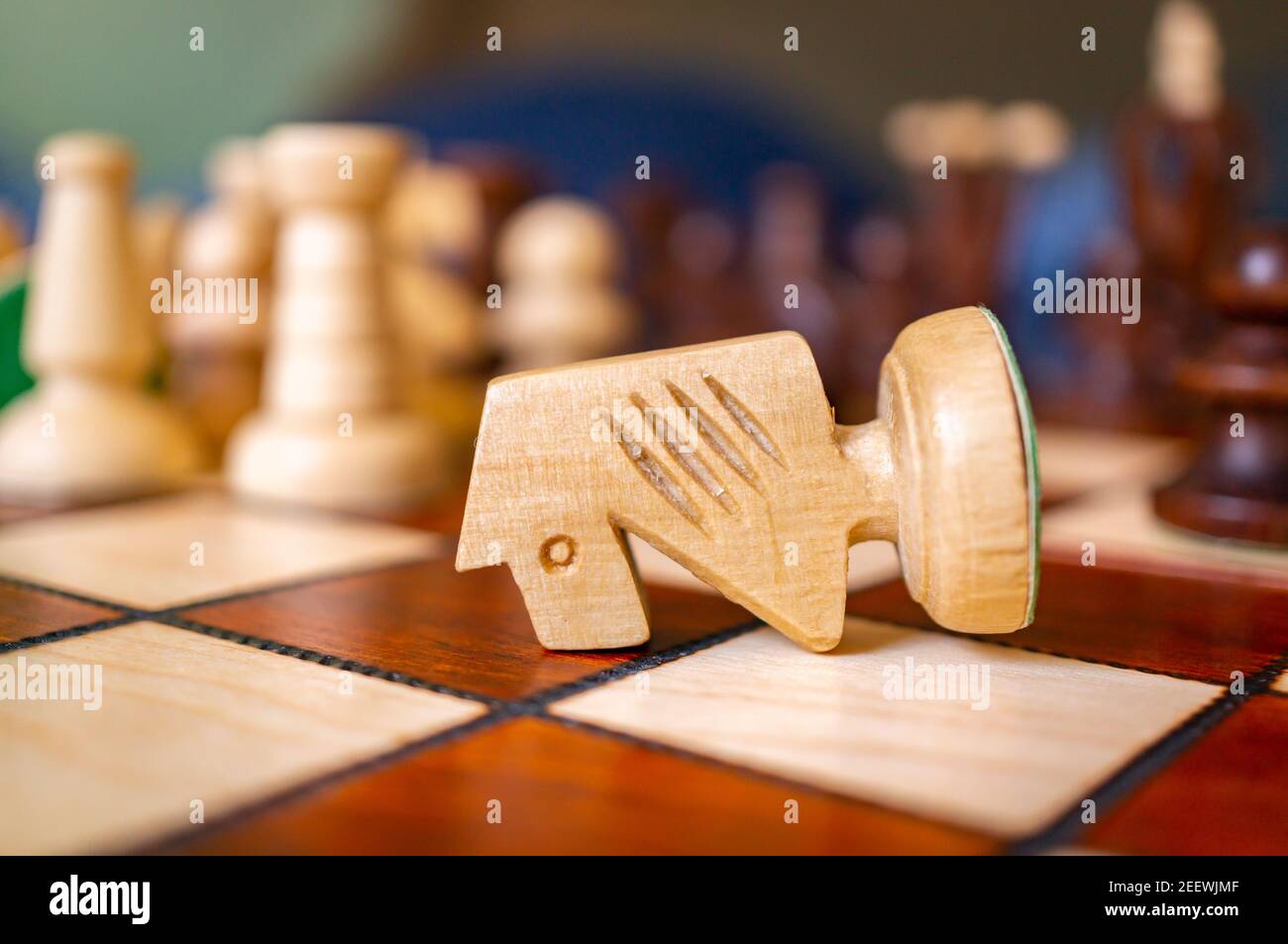 Fallen chess knight piece on a chessboard Stock Photo - Alamy