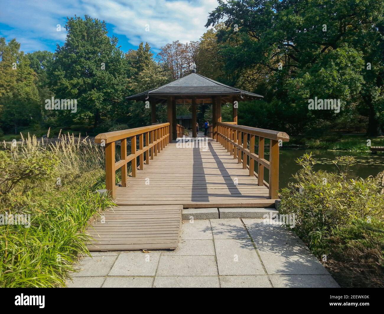 Wooden bower with wooden bridge in japanese garden Stock Photo - Alamy