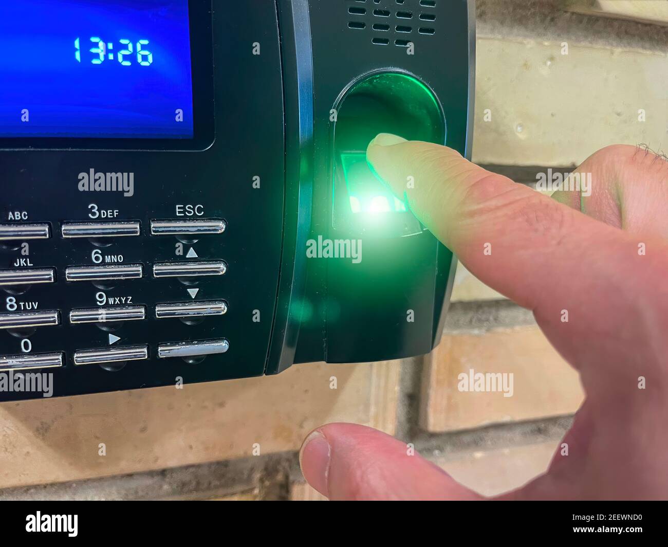close up of a finger placed on an access control terminal with ...