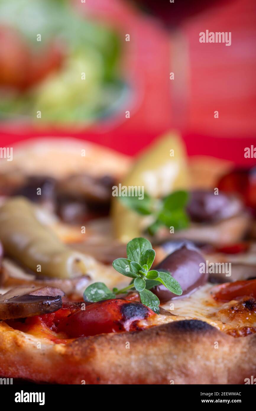 fresh pizza on a red background Stock Photo - Alamy