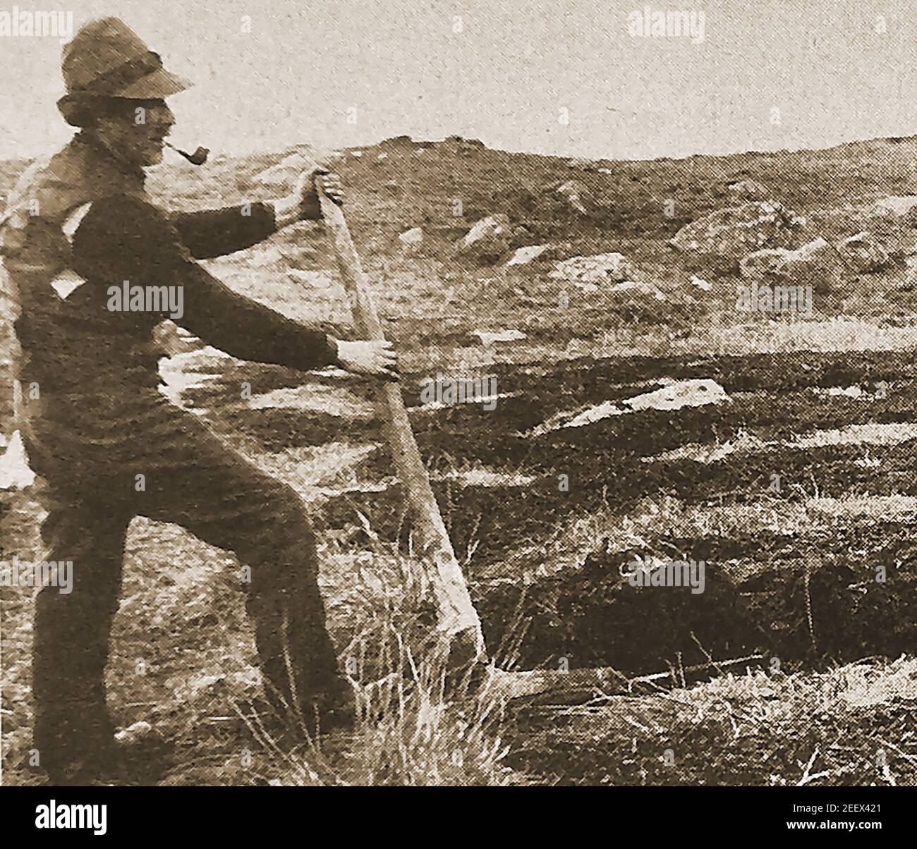 An old press photograph of a Scottish crofter in the Hebrides using a ...