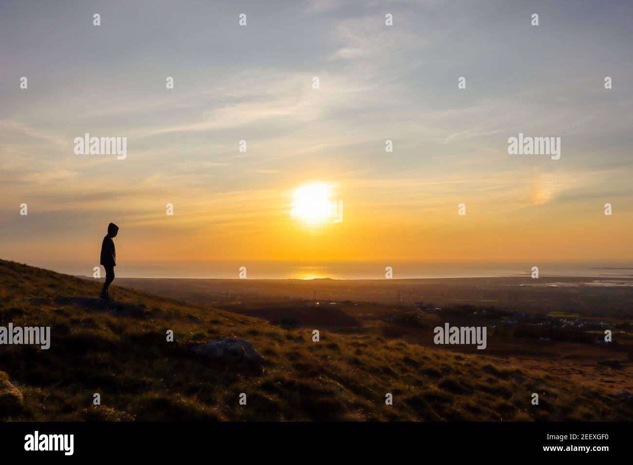 Man silhouette standing watching Sunset on the horizon, Rhosgadfan ...