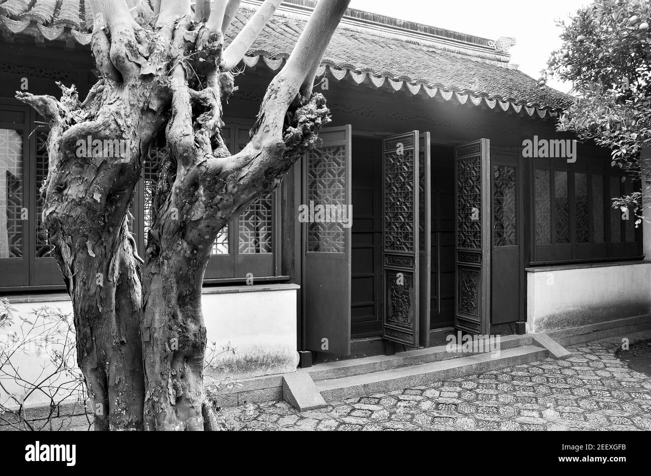 Grayscale shot of the entrance open doors of the temple Stock Photo - Alamy
