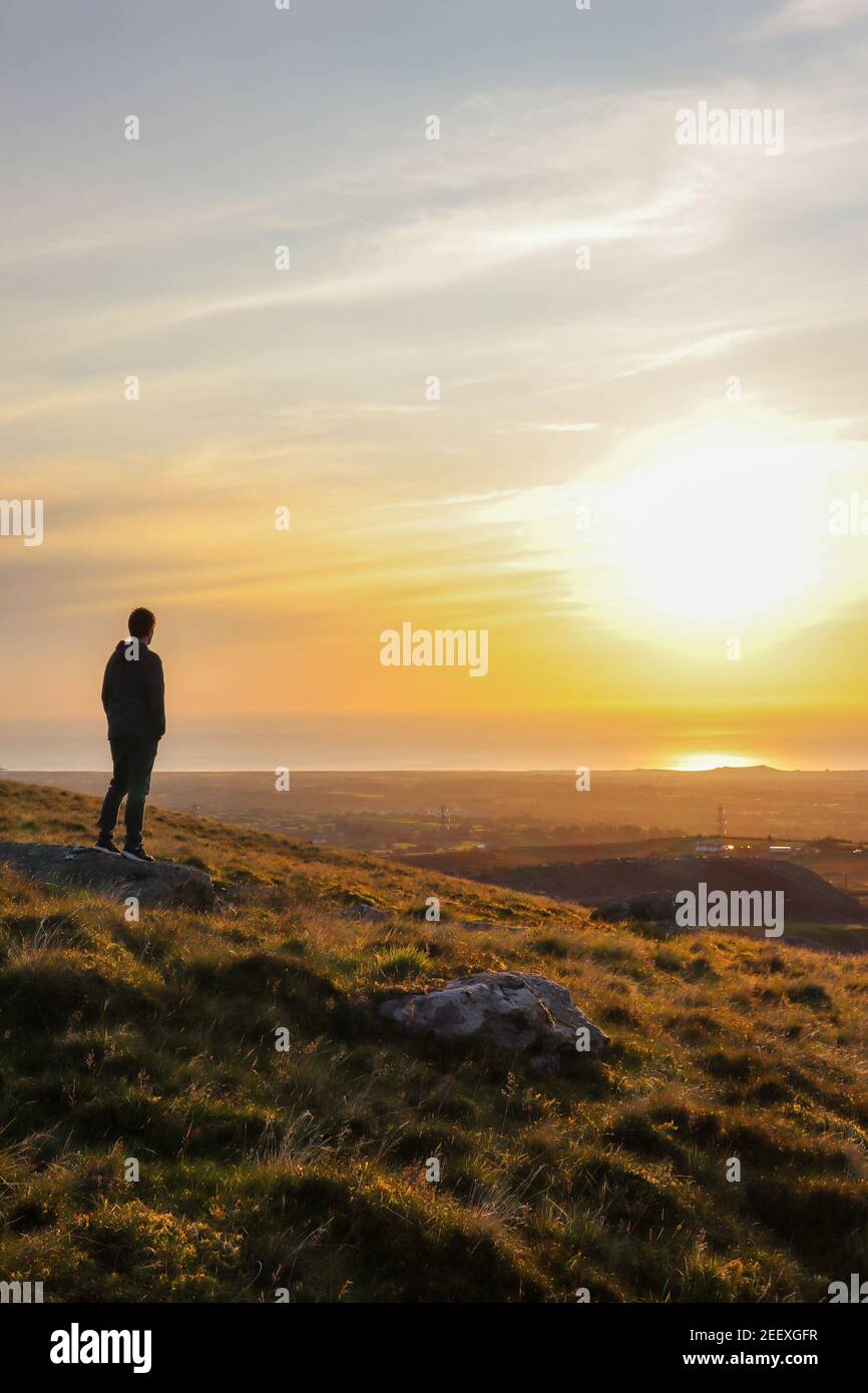 Man silhouette standing watching Sunset on the horizon, Rhosgadfan ...
