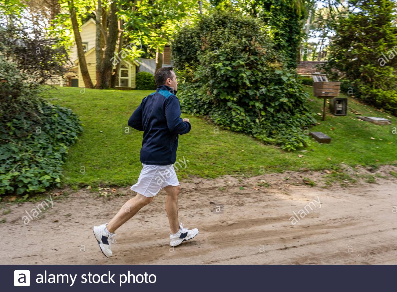 Male athlete walking after running outdoors Stock Photo - Alamy