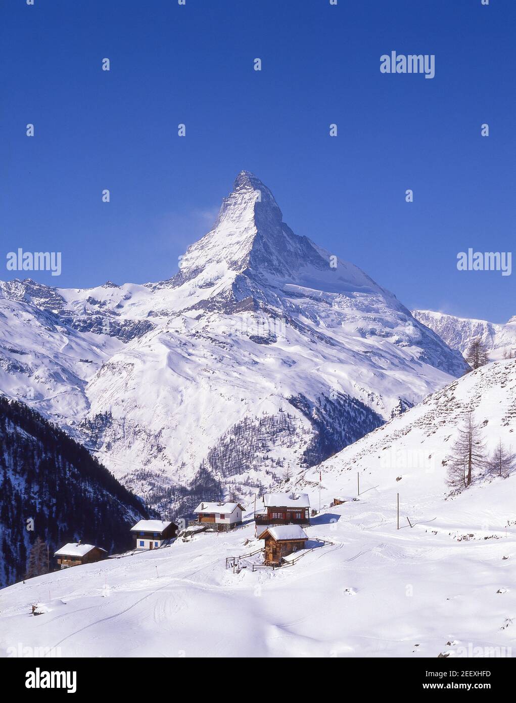 Mountain huts and ski slope with Matterhorn Mountain behind, Zermatt ...