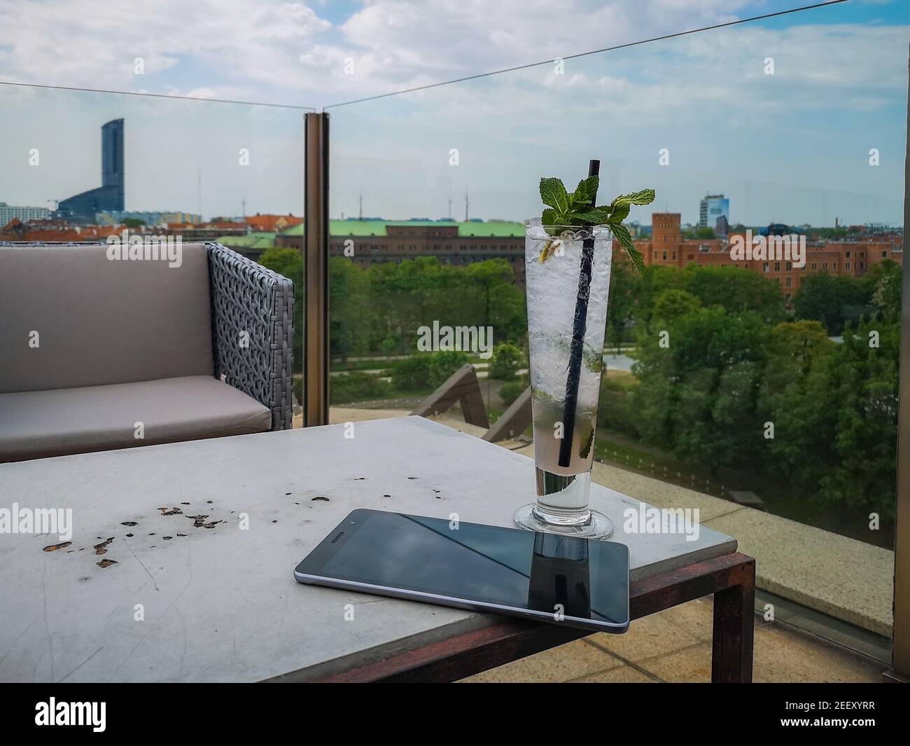 Work on terrace with tablet drinking lemonade with colorful look from ...