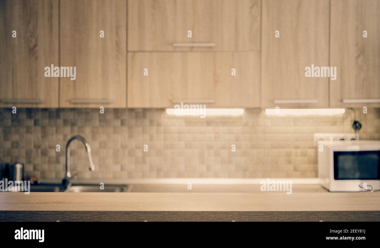 blurred kitchen interior and wooden desk space home background Stock ...
