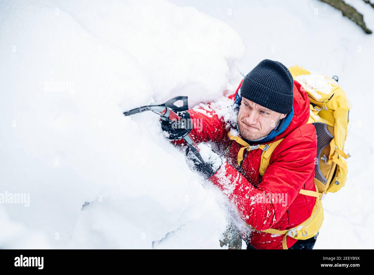 Handsome mountaineer with an ice ax.. Effort when climbing Stock Photo ...