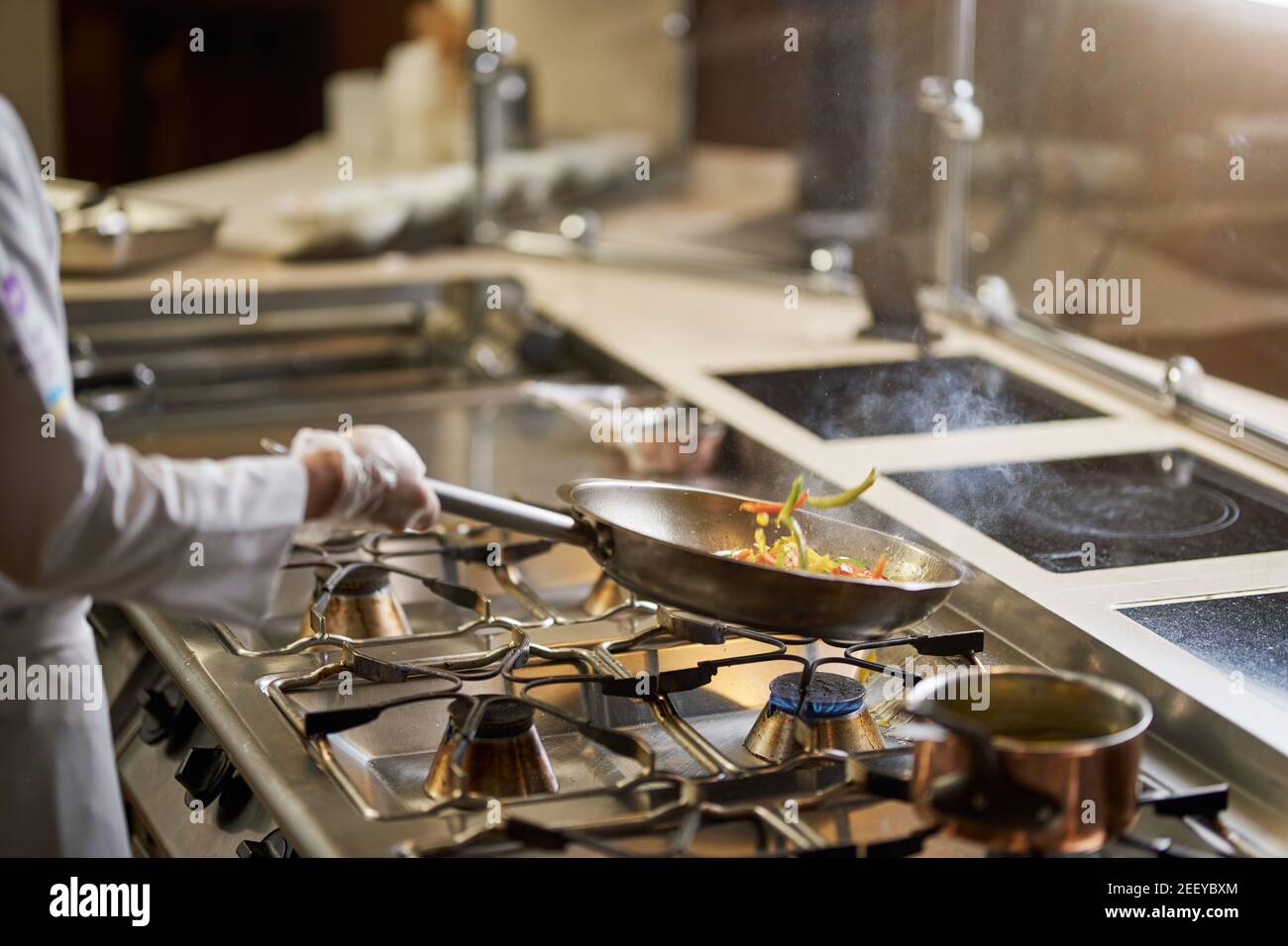 Chef stirring food shaking pan hi-res stock photography and images - Alamy