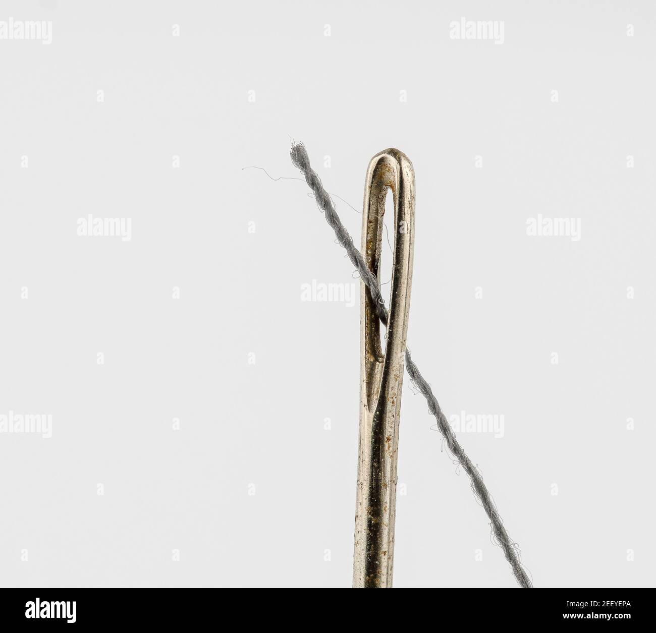 Macro image of a sewing needle eye and thread Stock Photo - Alamy