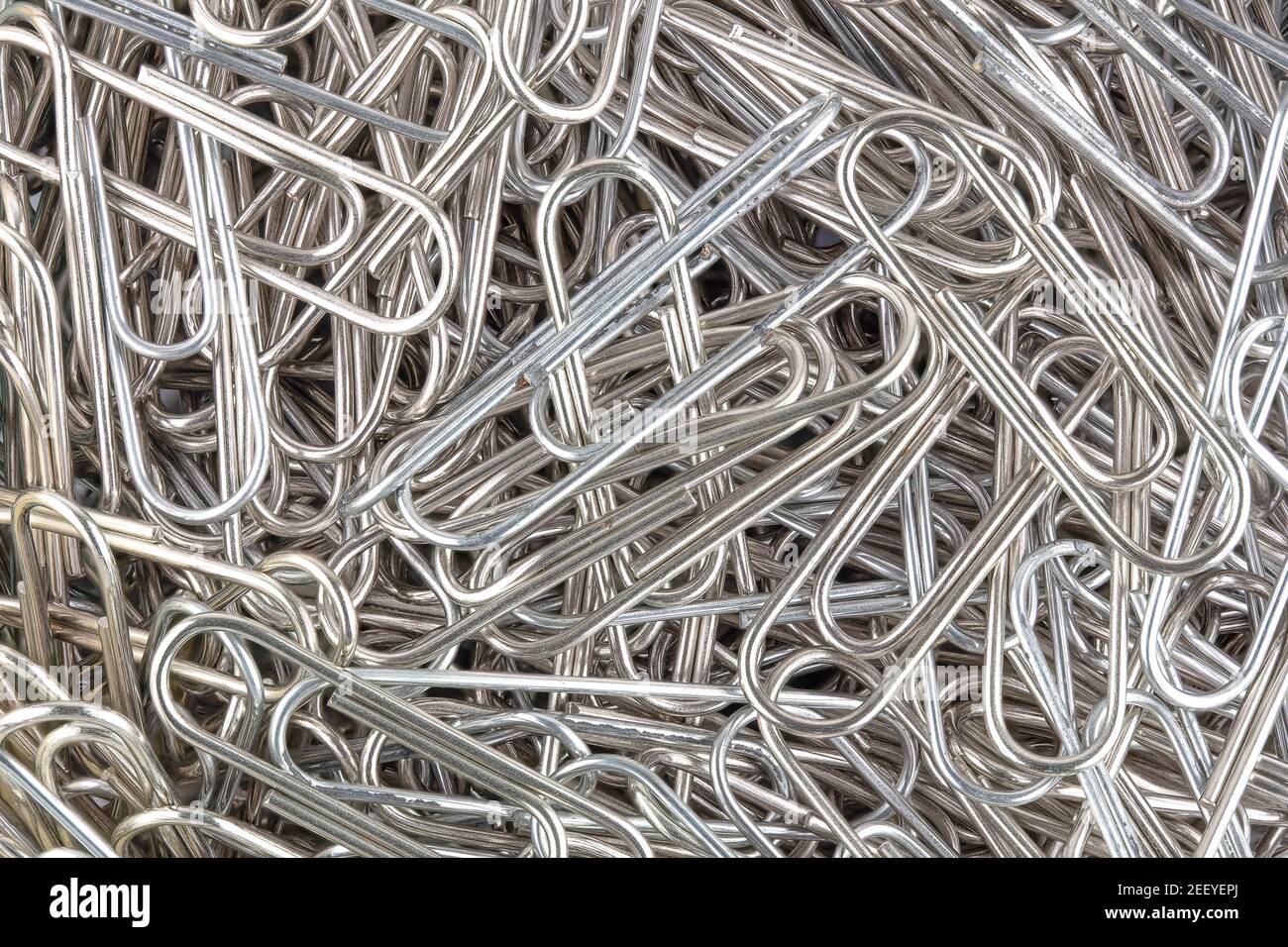 Lots of silver paper clips full image background Stock Photo - Alamy