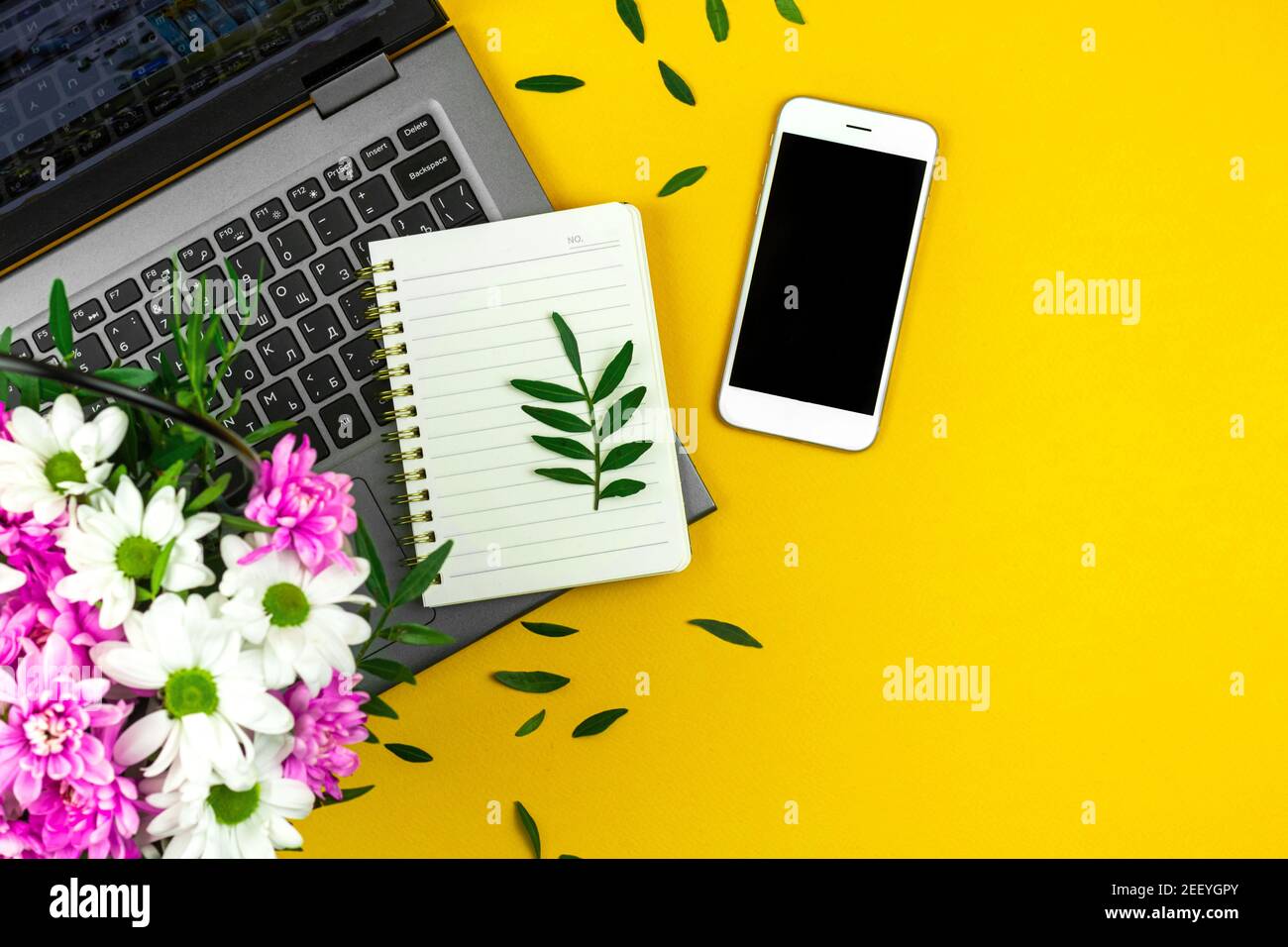 Spring office background, workspace with bouquet of flower, yellow ...