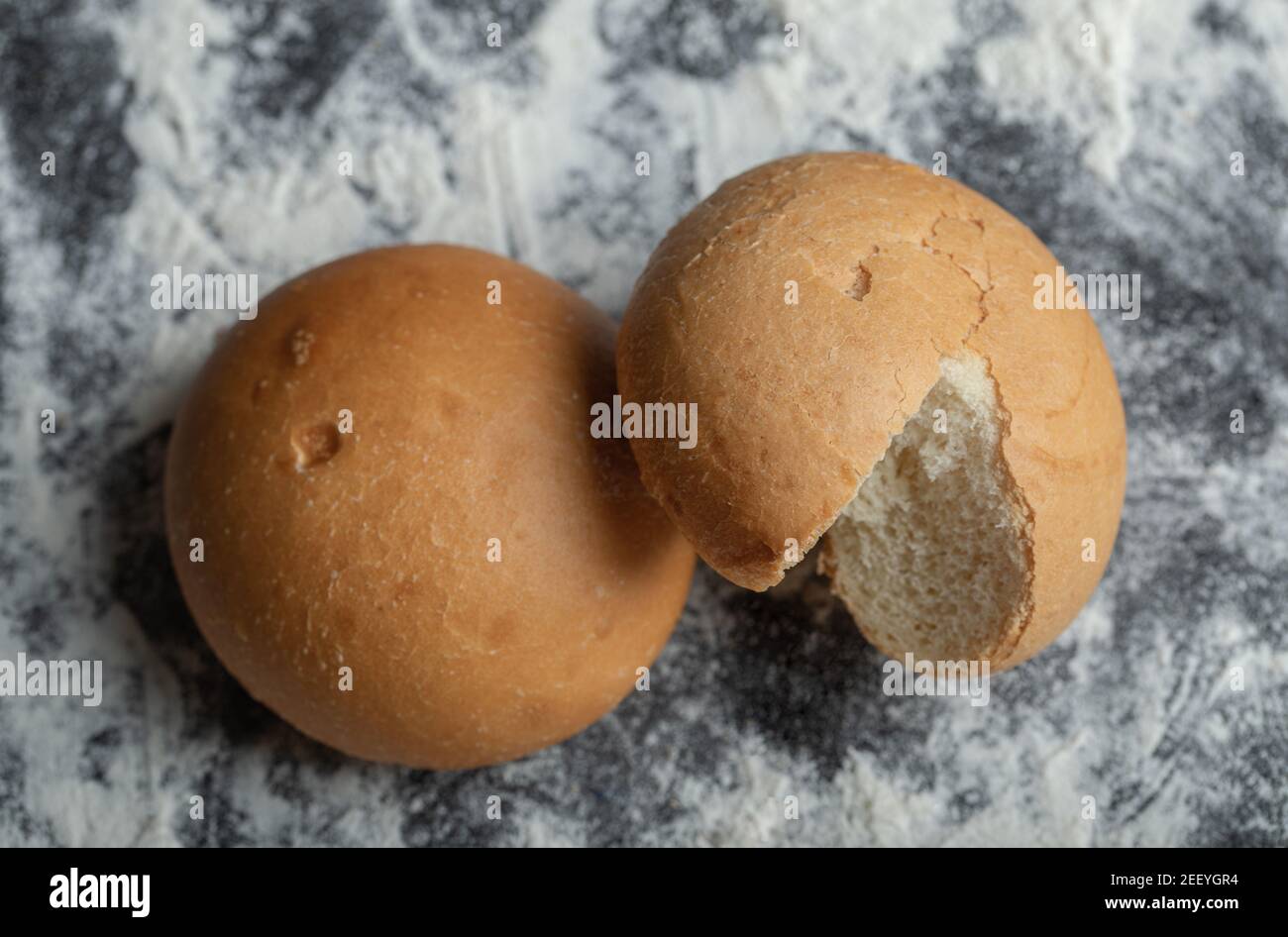 Small French bread's pieces on flour background Stock Photo - Alamy