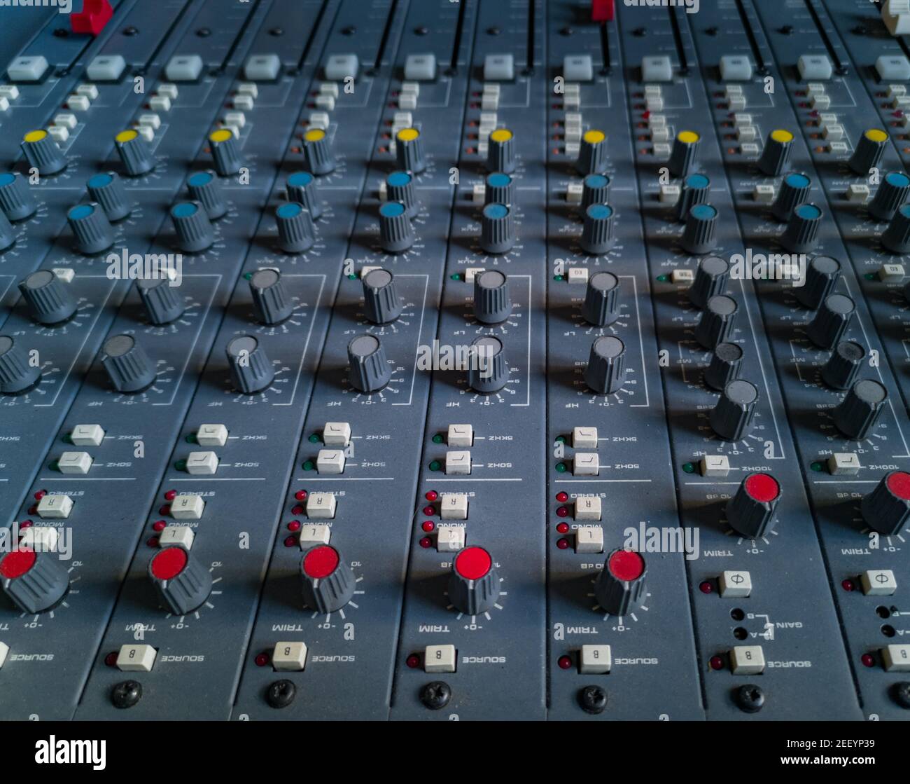 Front panel of old music radio console with colorful potentiometers and ...