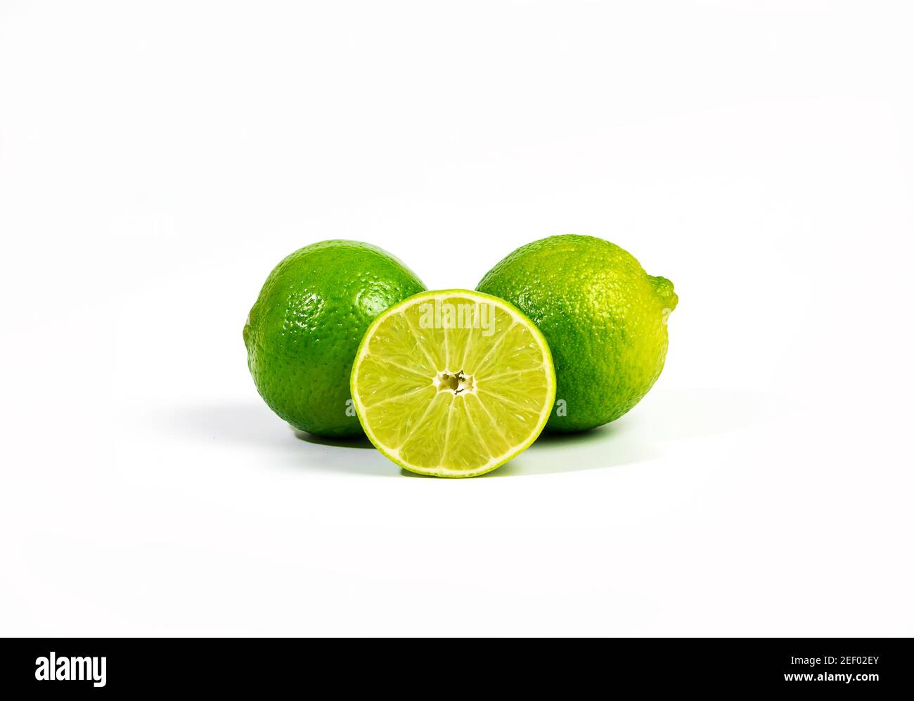 Two whole limes and slice of lime fruit isolated on white background ...