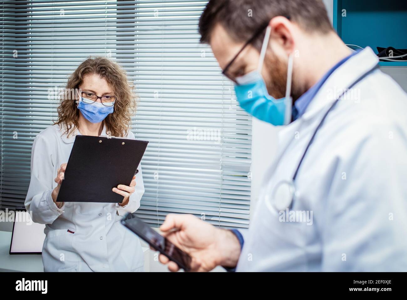 two doctors discussing diagnostics team work Stock Photo - Alamy
