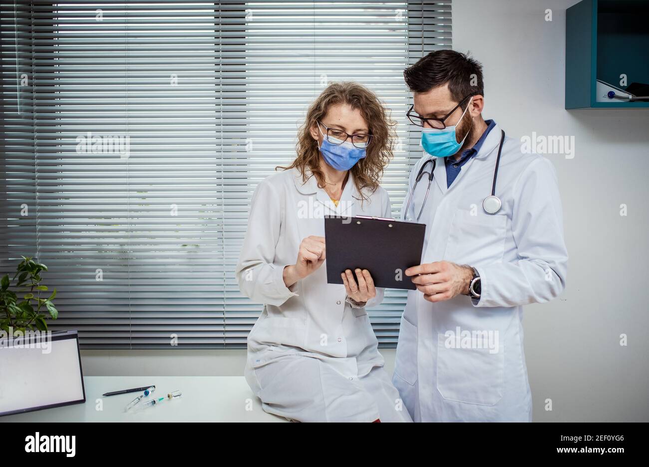 two doctors discussing diagnostics team work Stock Photo - Alamy