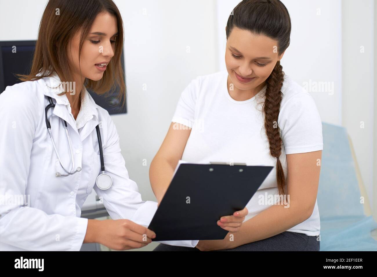 Beautiful woman in expectation visiting doctor at modern clinic. Female ...