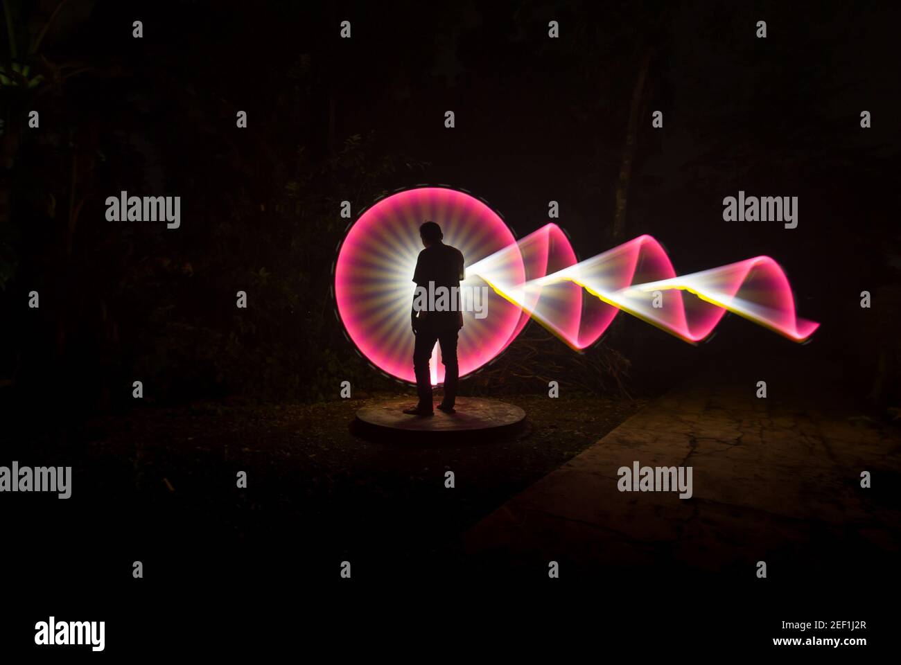 One person standing alone against beautiful color circle LED light ...