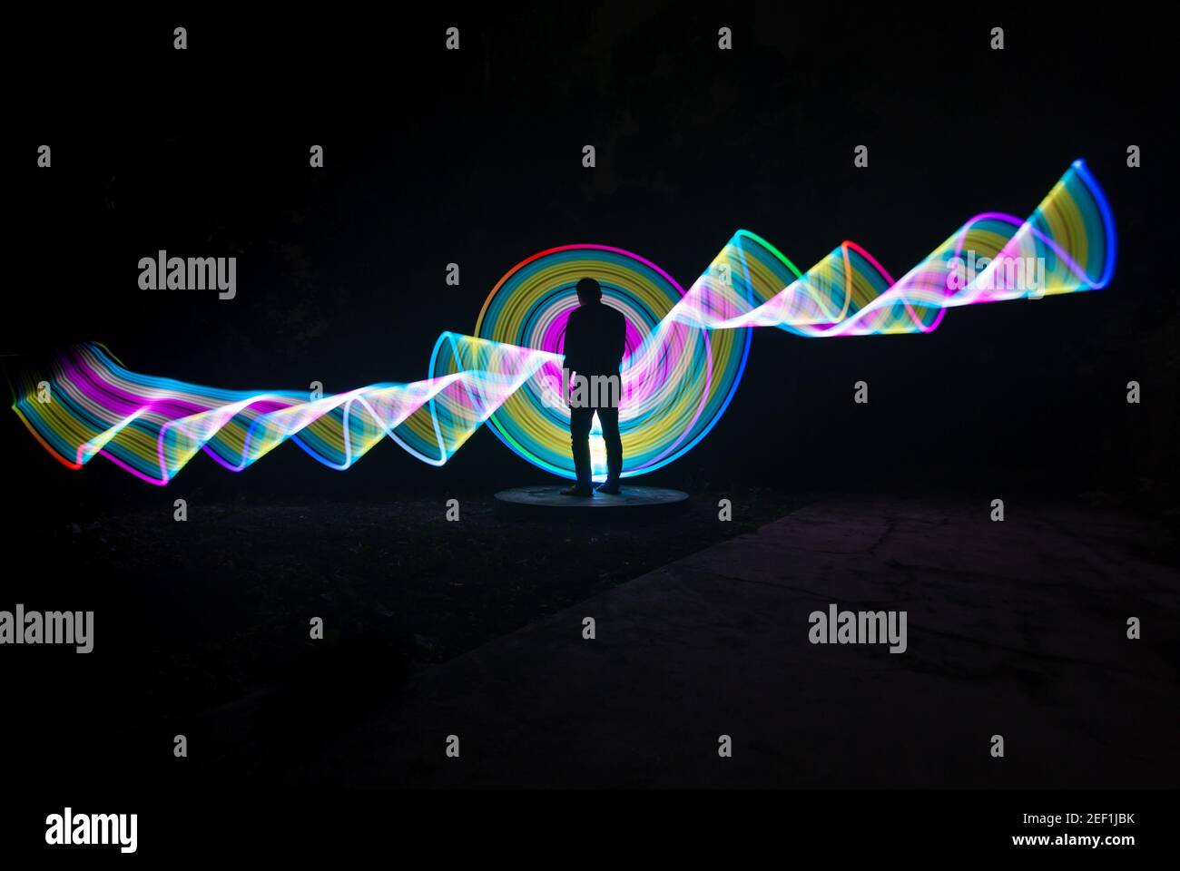 One person standing alone against beautiful color circle LED light ... One person standing alone against beautiful color circle LED light ...