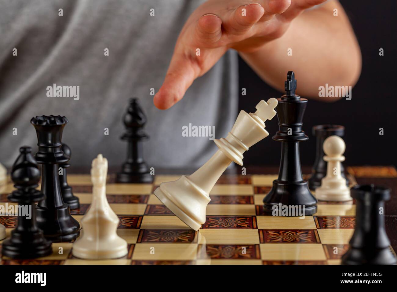Close up image of the end of a chess came where the losing player ...