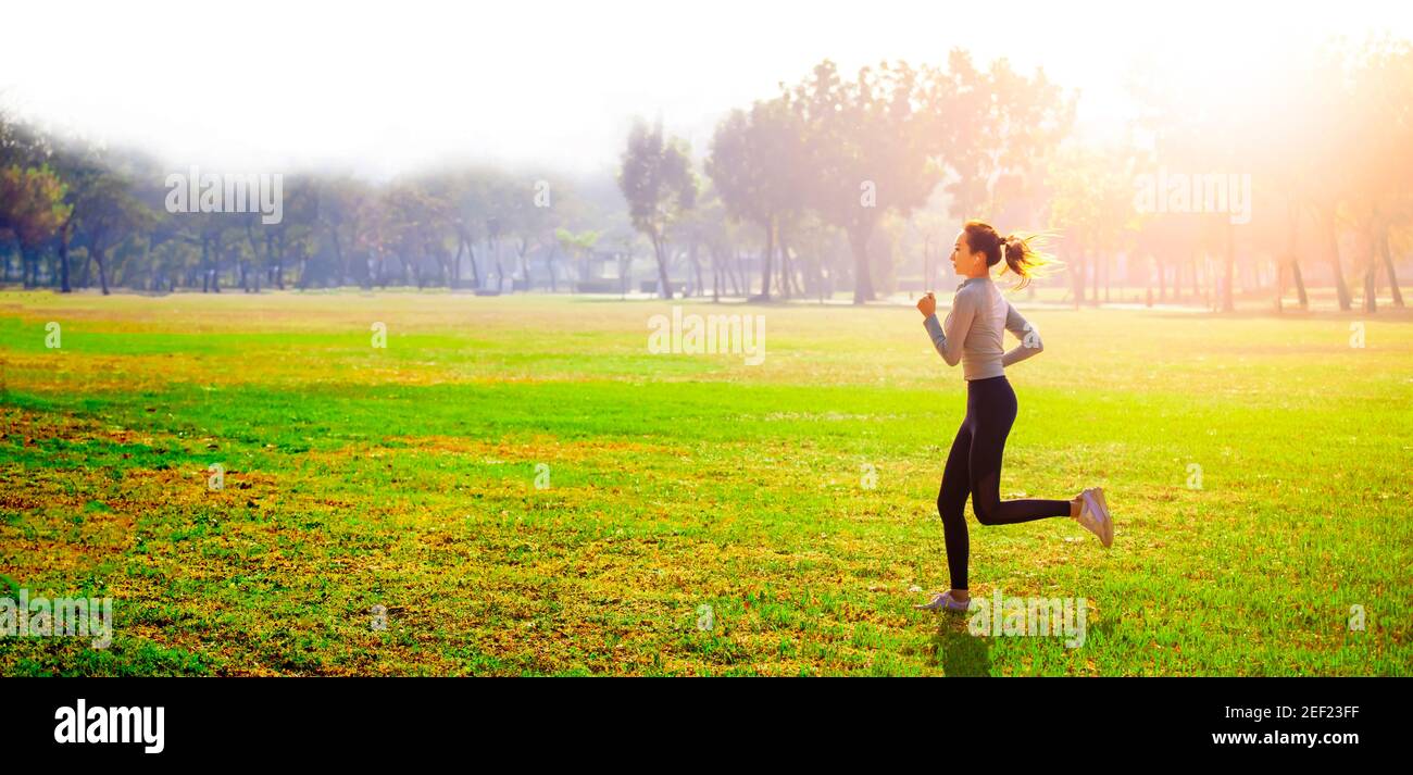 Young beautiful woman running on grass field at morning Stock Photo - Alamy