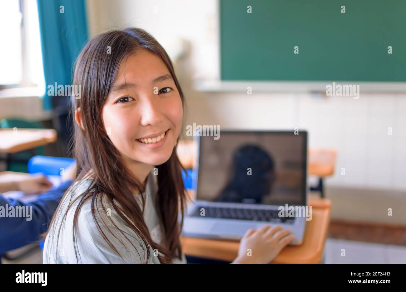happy asian Student girl using laptop in classroom Stock Photo - Alamy