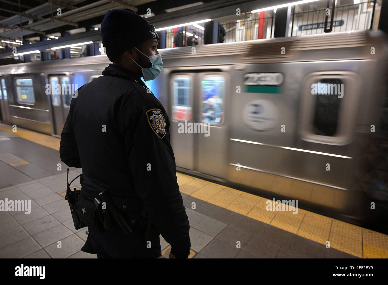 New York, USA. 16th Feb, 2021. An NYPD officer is seen on the downtown ...
