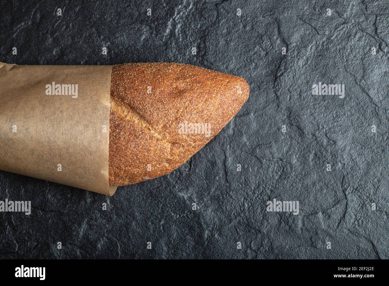 Top view of British baton loaf bread on black background Stock Photo ...