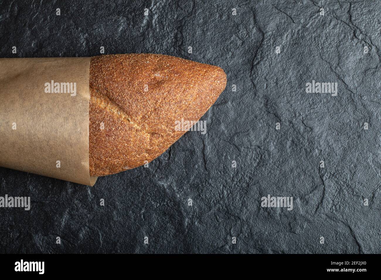 Top view of British baton loaf bread on black background Stock Photo ...