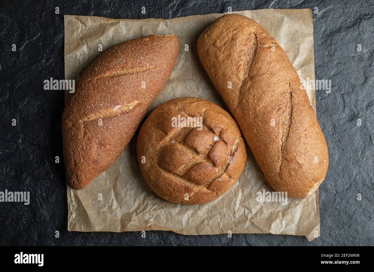 three Different loaves bread on black background Stock Photo - Alamy