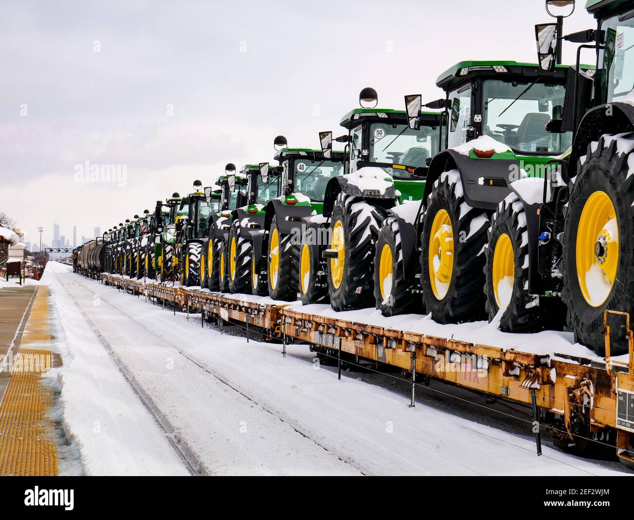 Railroad flatcars loaded with John Deere tractors for export. Oak Park, Illinois. Downtown ...