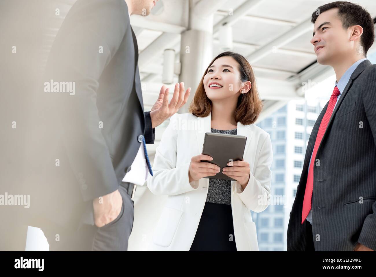 Group of business colleagues talking at outdoor covered walkway Stock ...