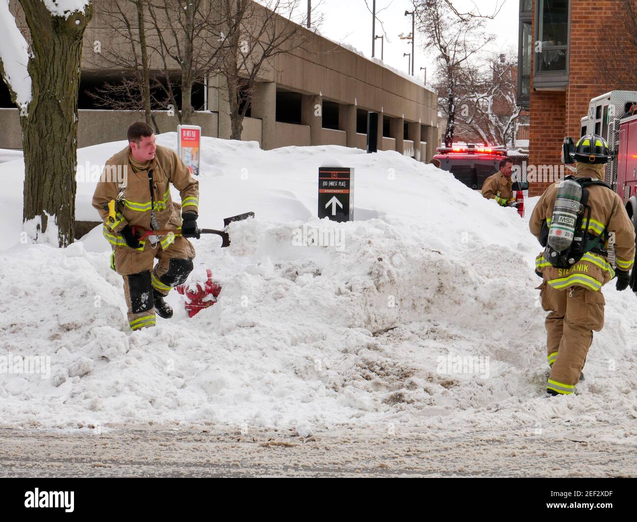 Firefighter digging out fire hydrant covered by heavy snow. Oak Park ...