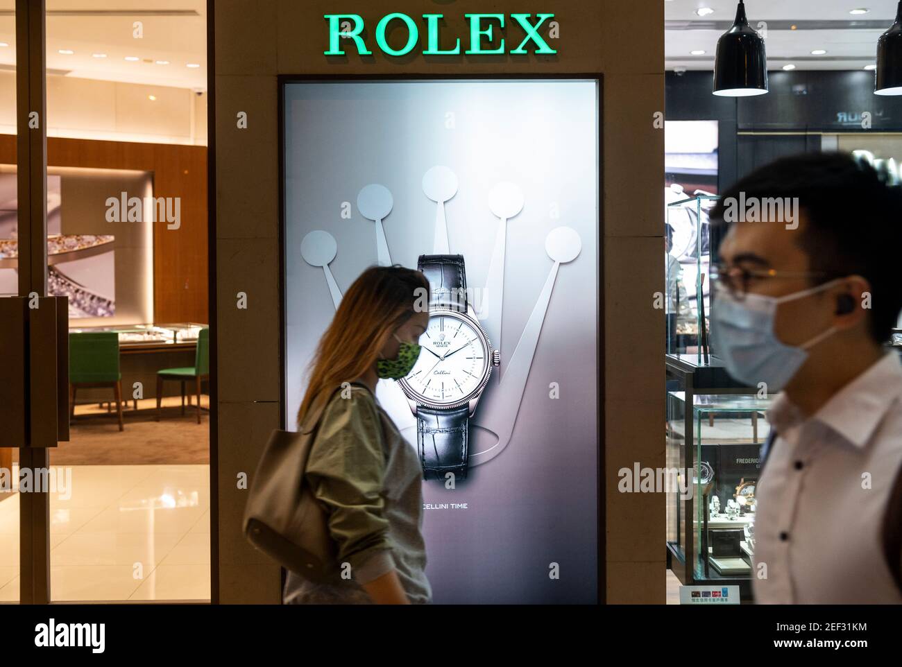 Pedestrians wearing masks seen in front of the Swiss luxury watchmaker ...