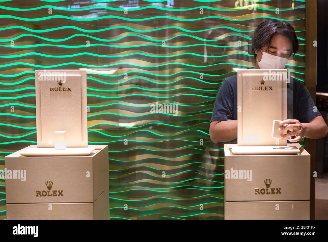 A Swiss luxury watchmaker Rolex staff is seen packing the displayed ...
