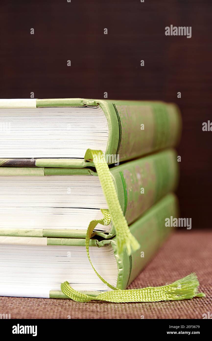 Stack of green books on the bookshelf in the library. Education ...