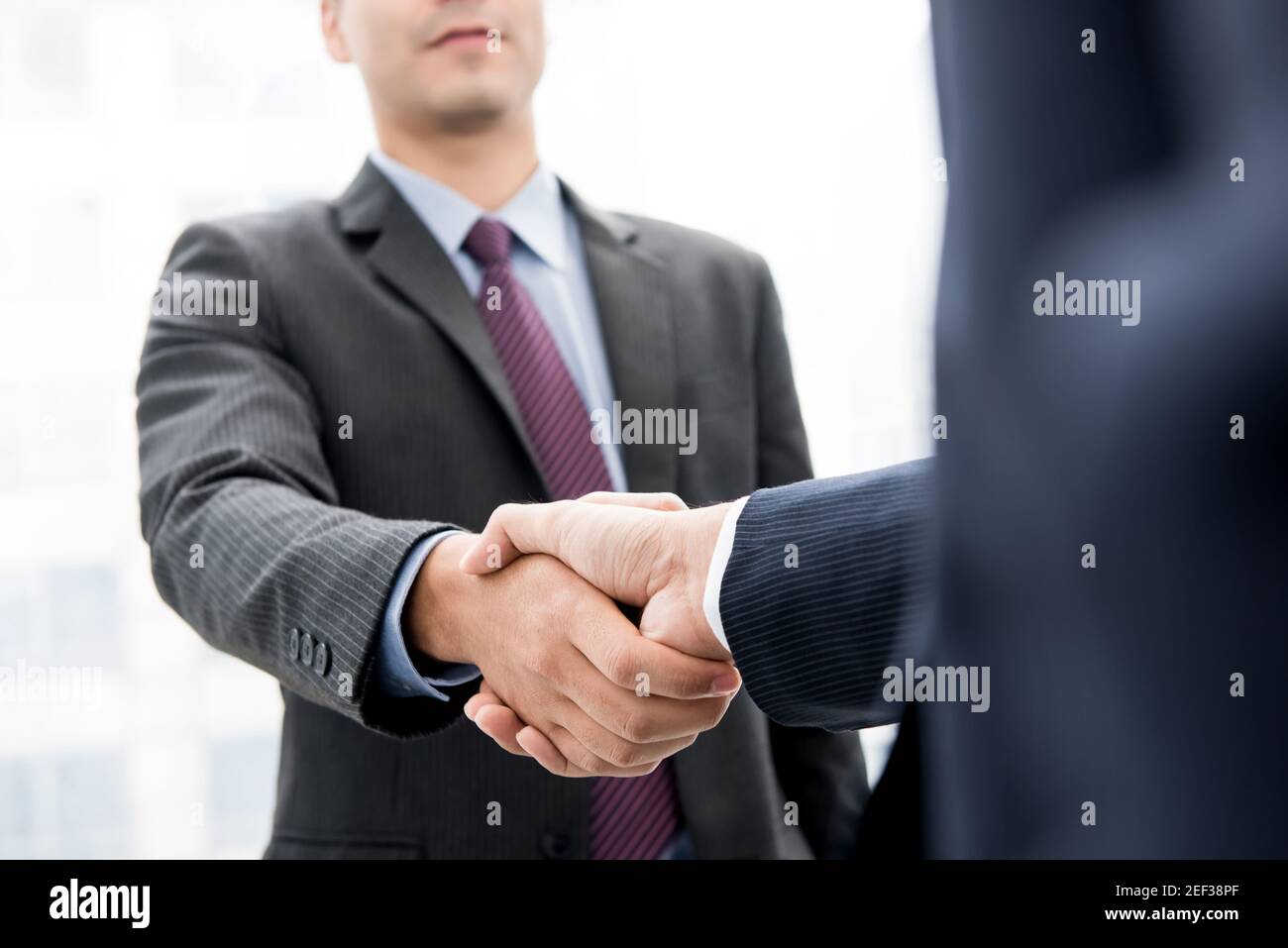 Businessmen making handshake - greeting, dealing, merger and ...