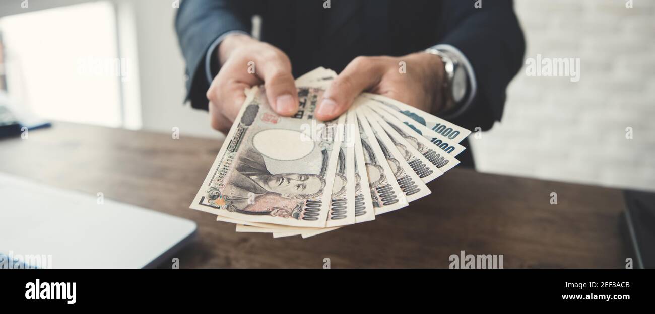 Businessman giving money, Japanese yen banknotes - panoramic web banner ...