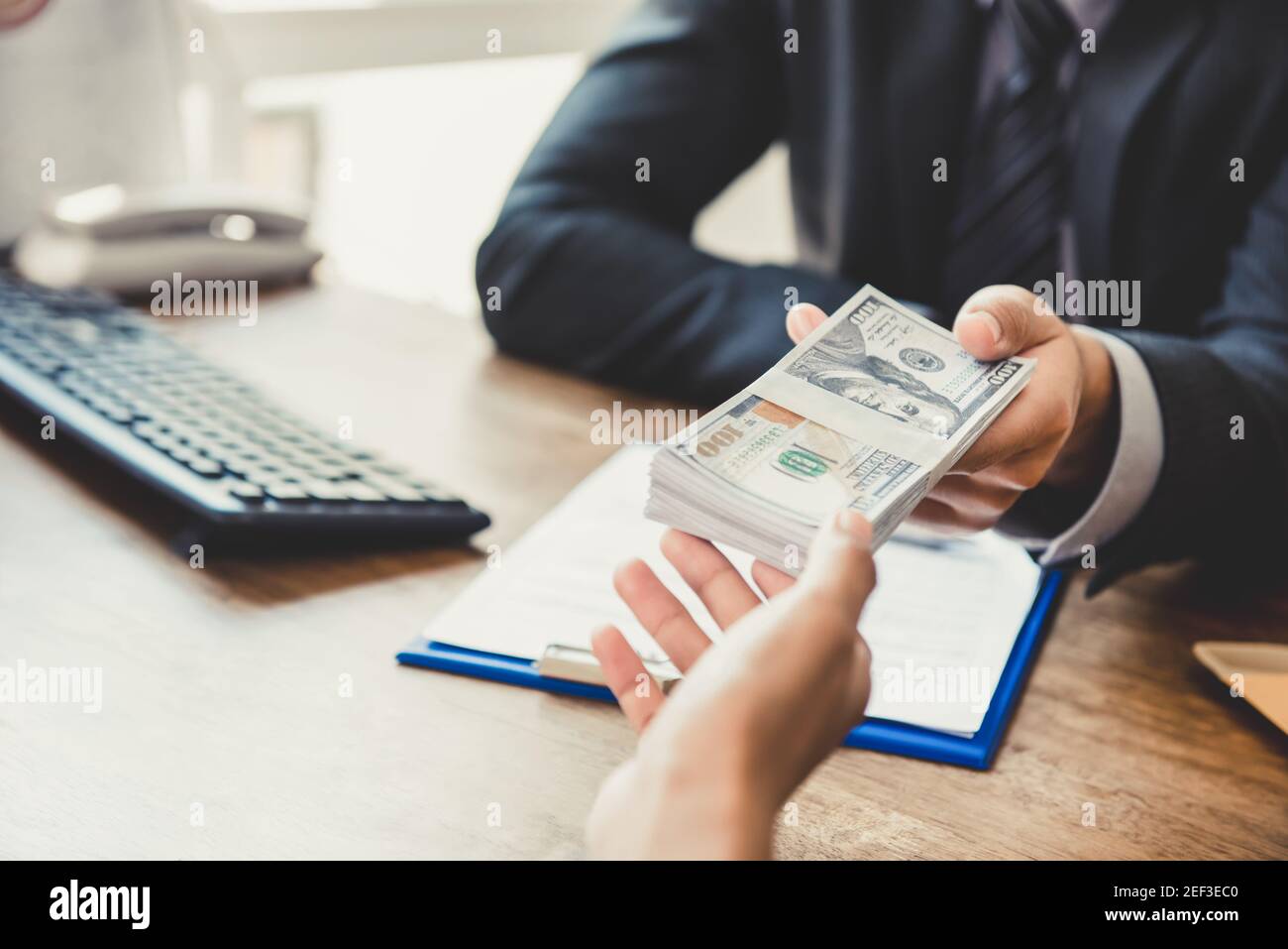 Businessman giving money to his partner while making contract - bribery ...