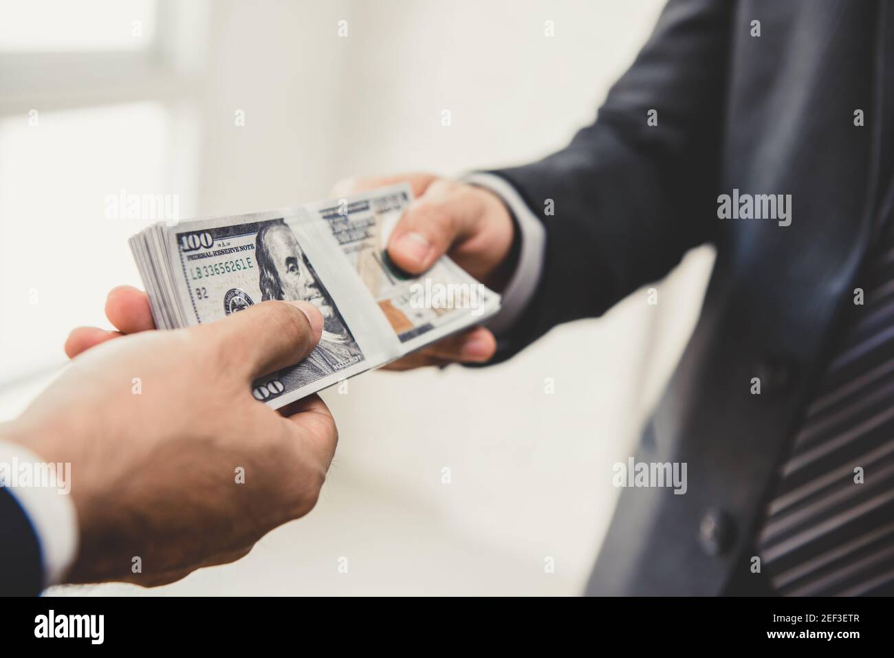 Businessman giving money, US dollar bills, to his partner - loan ...
