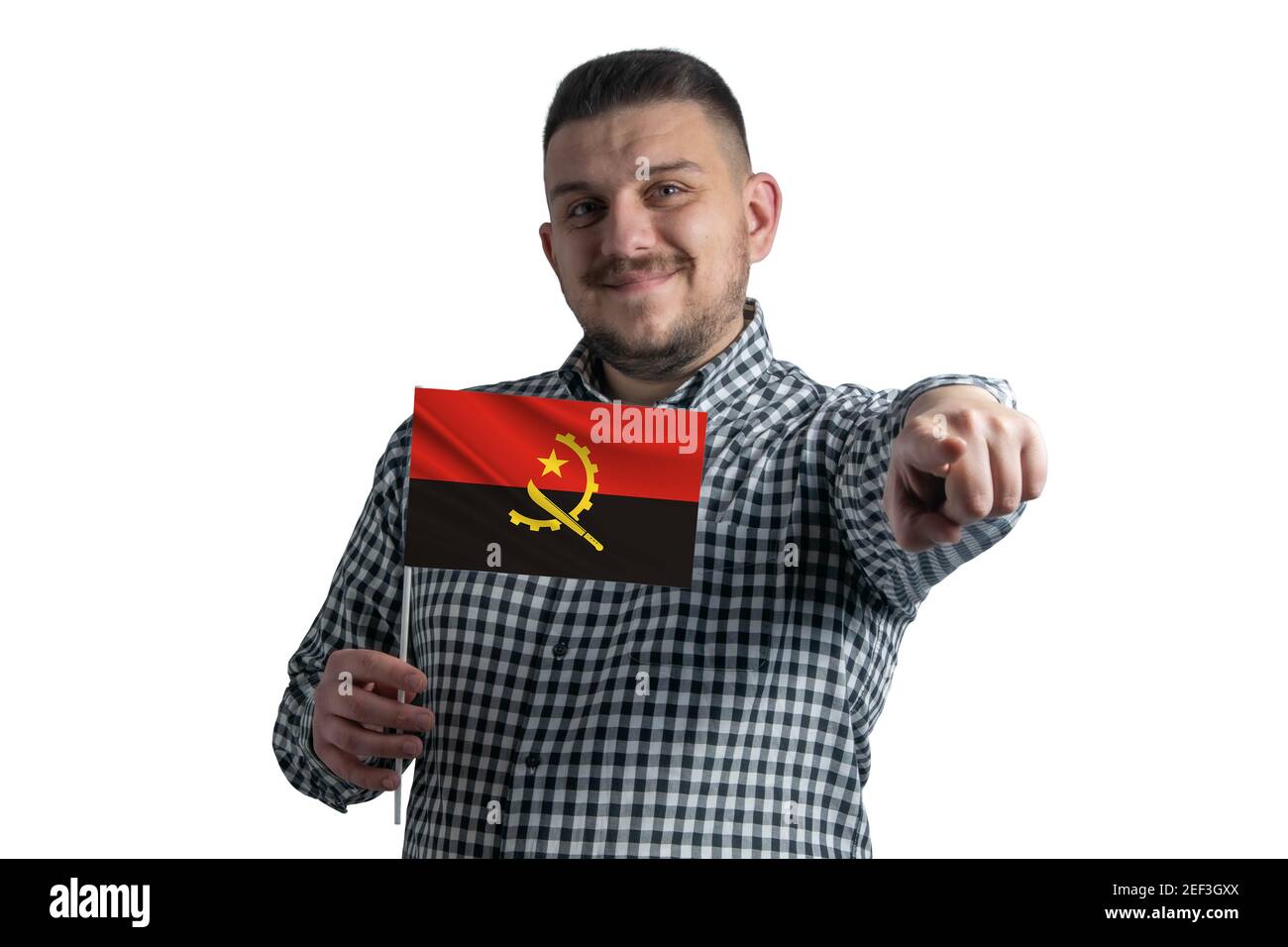 White guy holding a flag of Angola and points forward in front of him ...