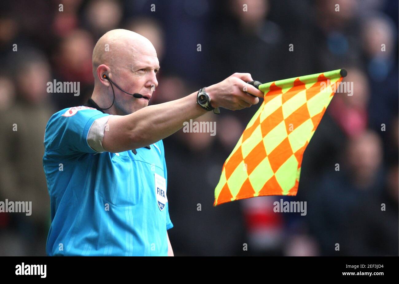 The assistant referee holds up his flag for offside hi-res stock ...