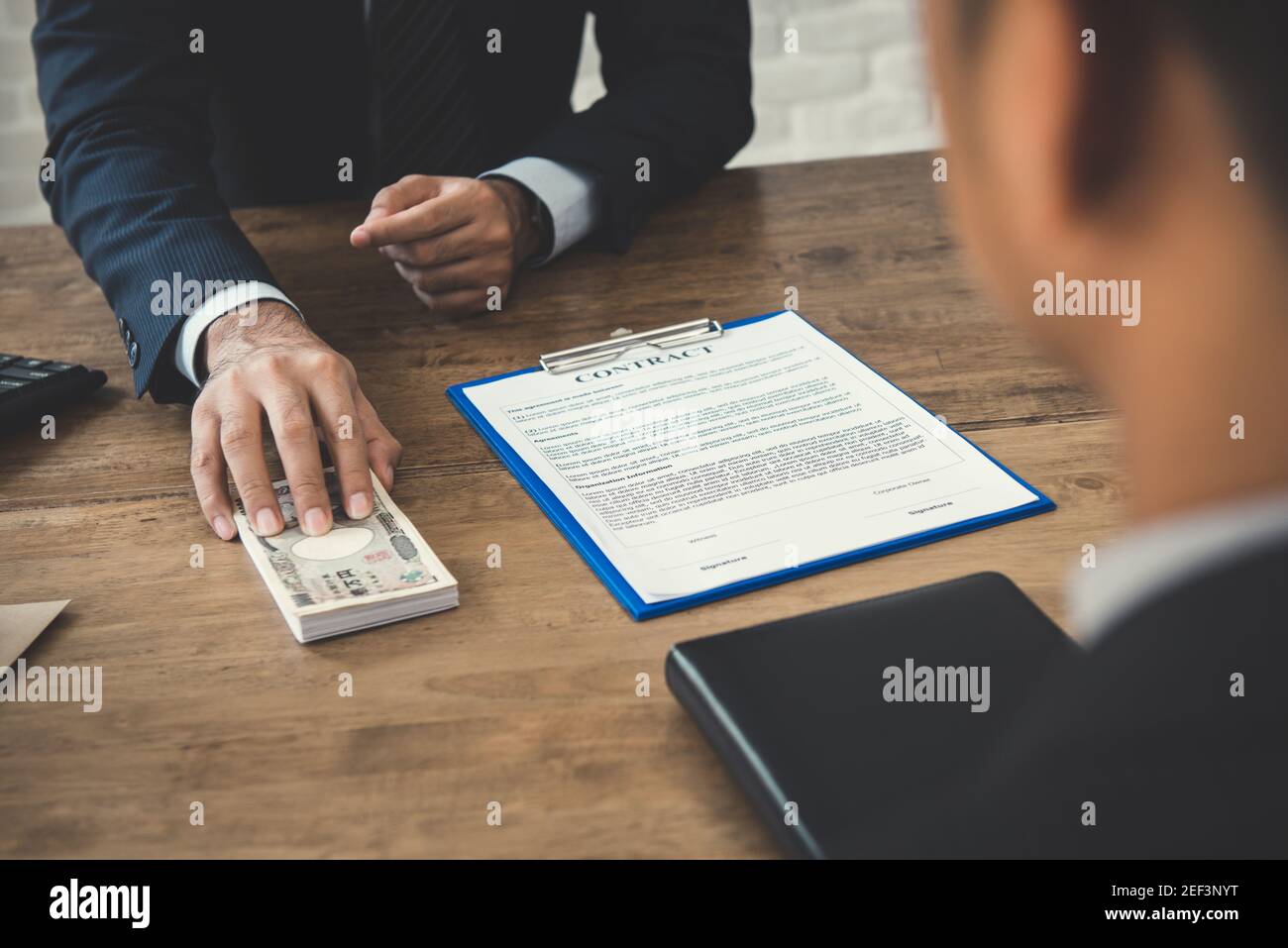 Businessman giving money, Japanese yen banknotes, while making contract ...